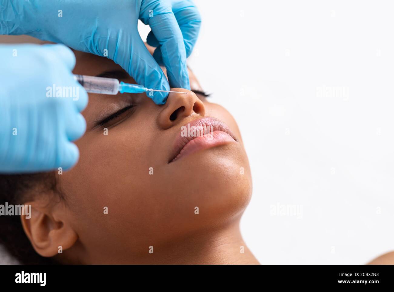 African american lady having filling injections for nose zone Stock ...