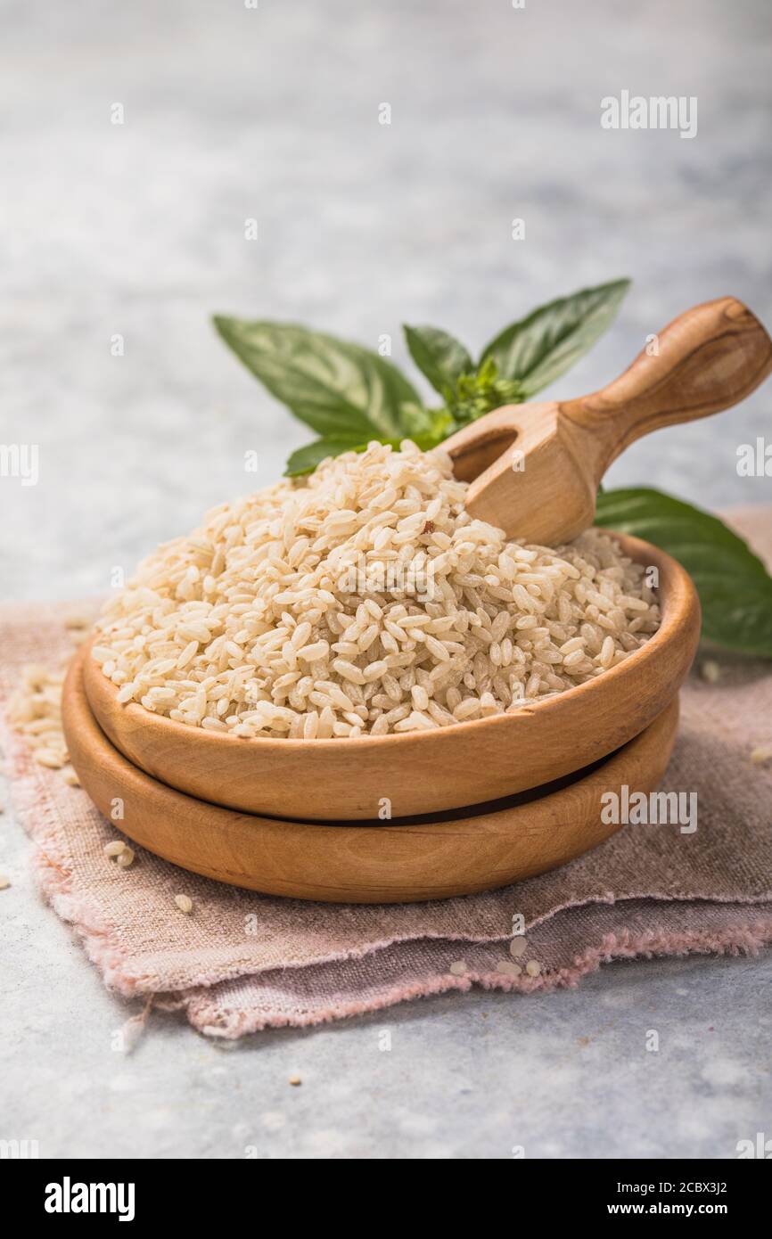 Unpolished brown rice in bowl Stock Photo - Alamy