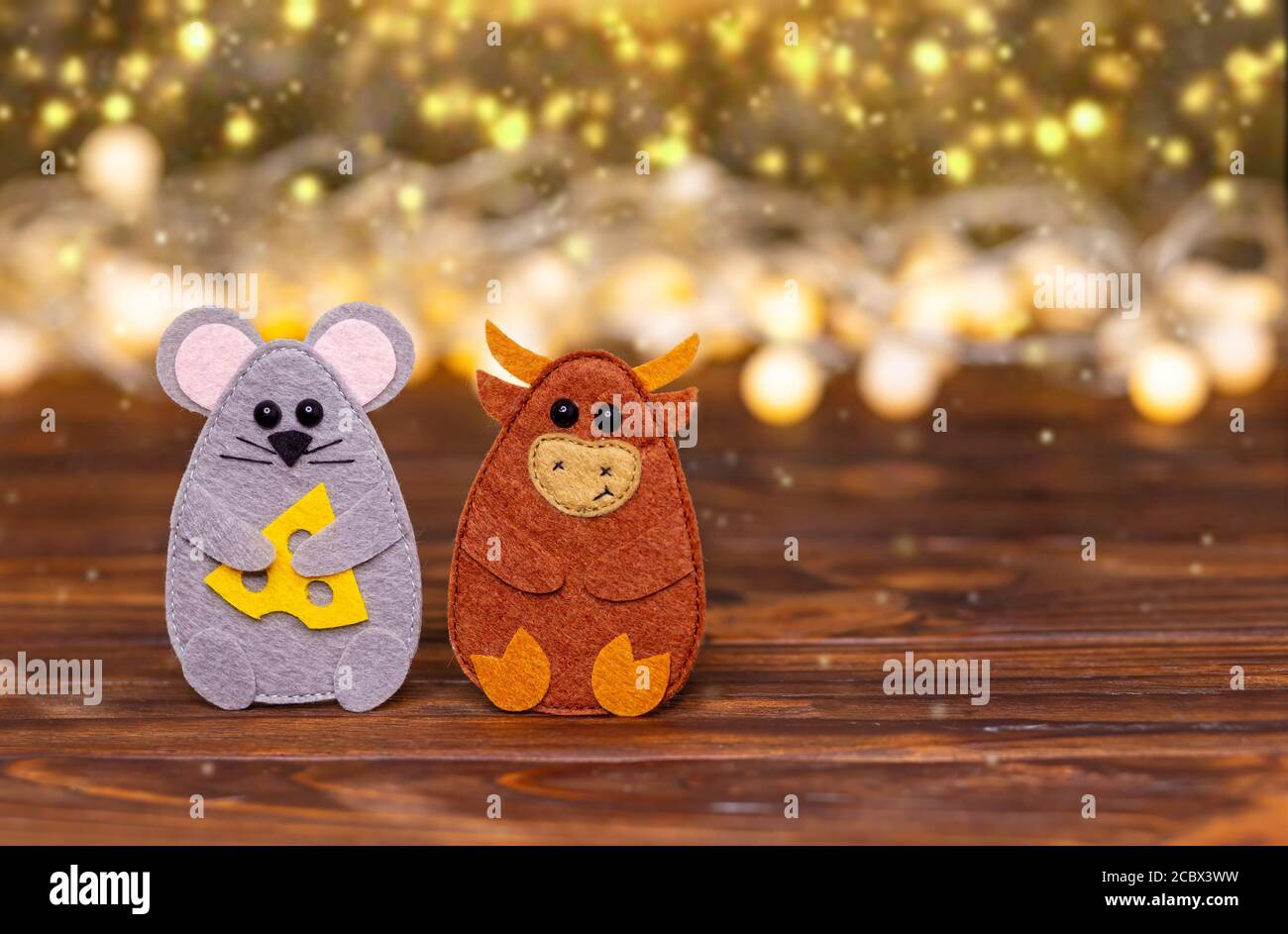 Chinese bull and mouse decorated with christmas lights on rustic wood ...