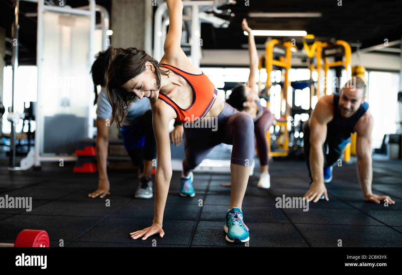 Beautiful fit people working out in gym together Stock Photo - Alamy