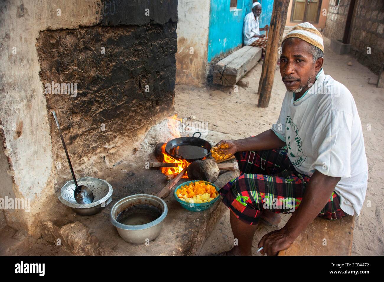 Cooking in the street in the slum of Wiyoni department in the northern ...