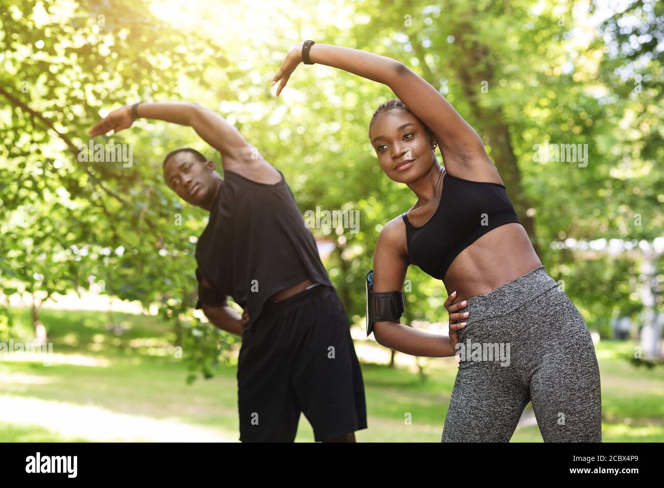 Outdoor Training. Athletic Black Couple Doing Sport Exercises Together ...