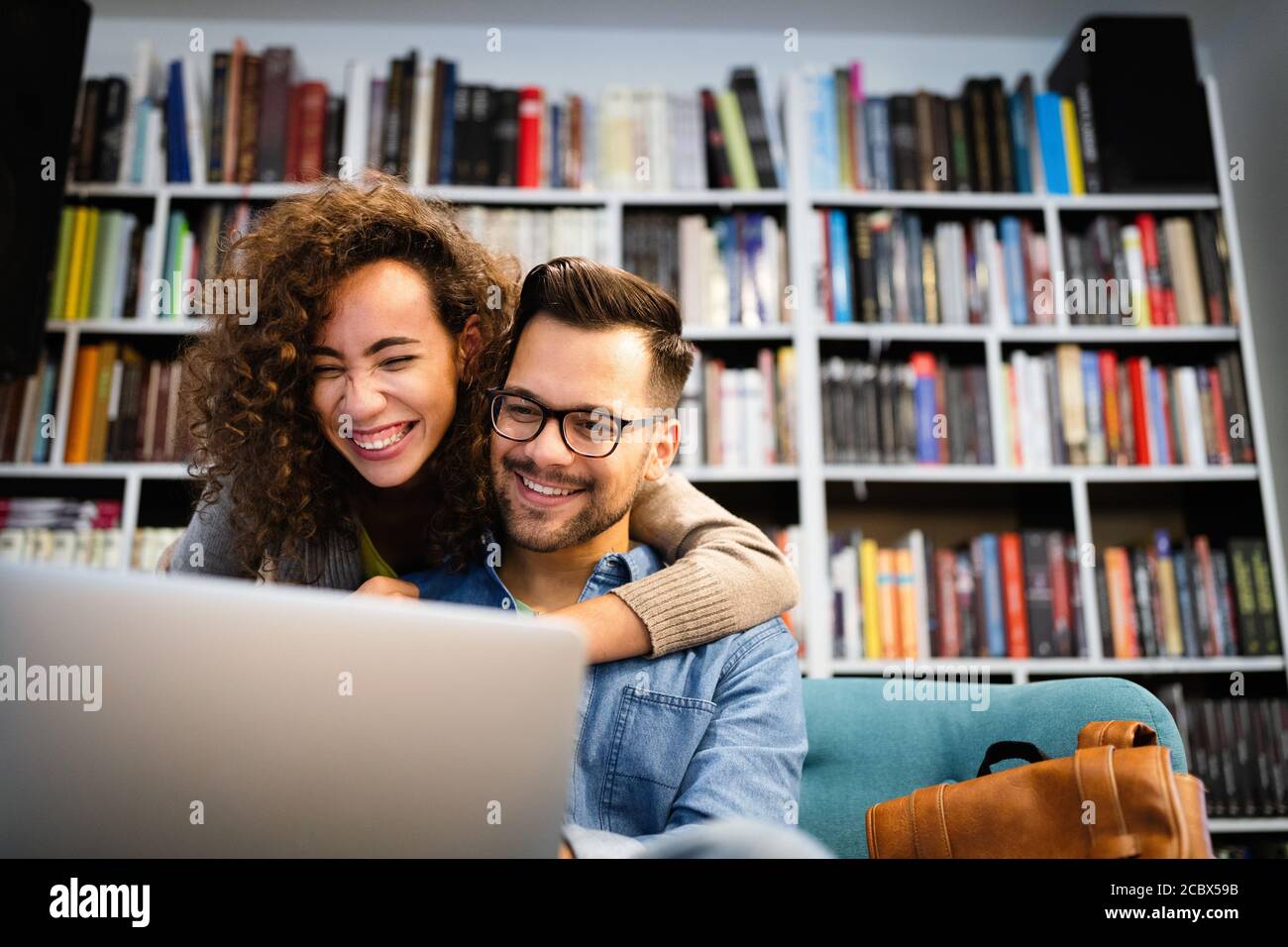 Students are studying together in library. Couple, study, technology ...