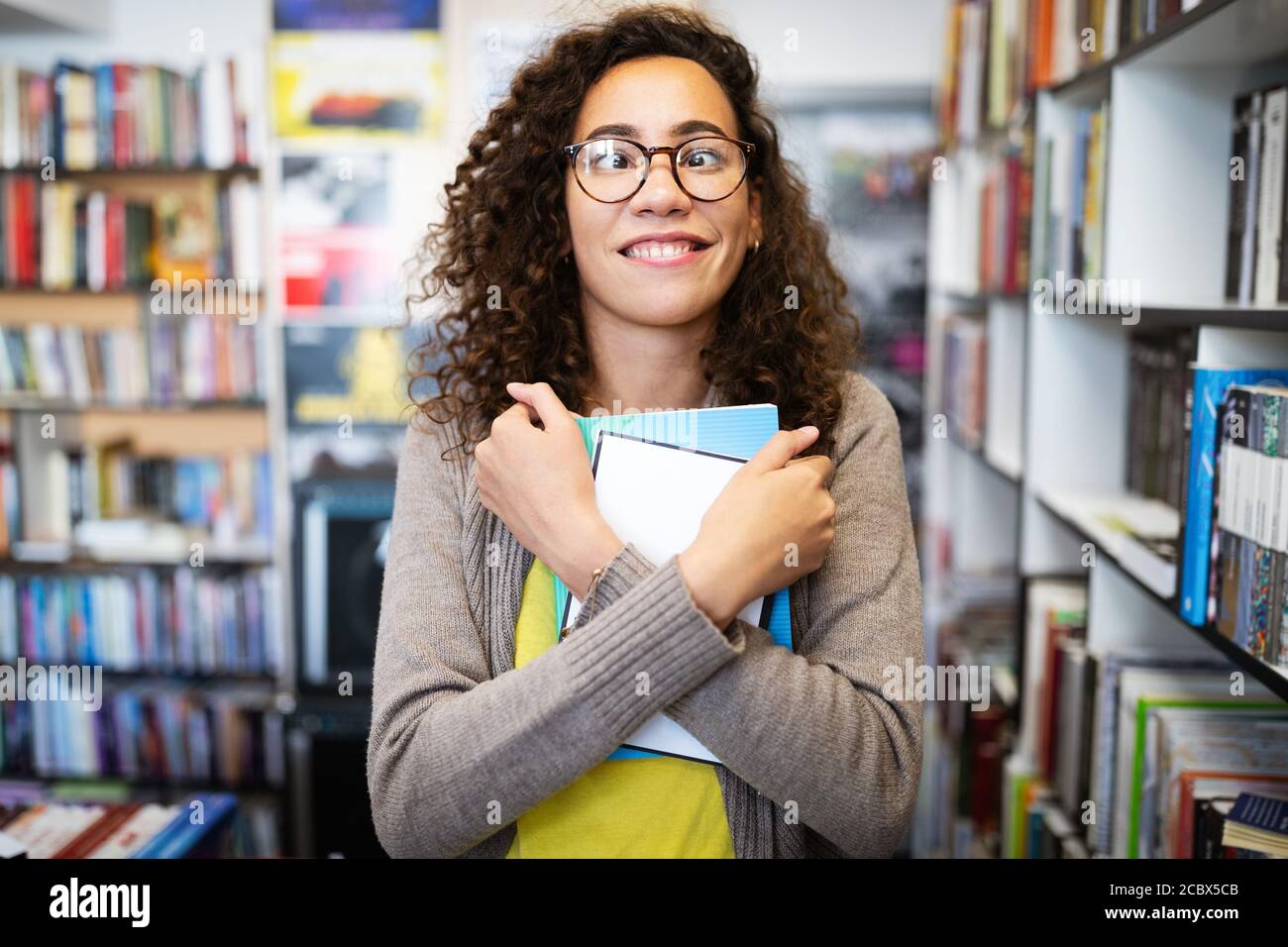 Ready to study hard. Happy nerd woman in library. Book lover Stock ...
