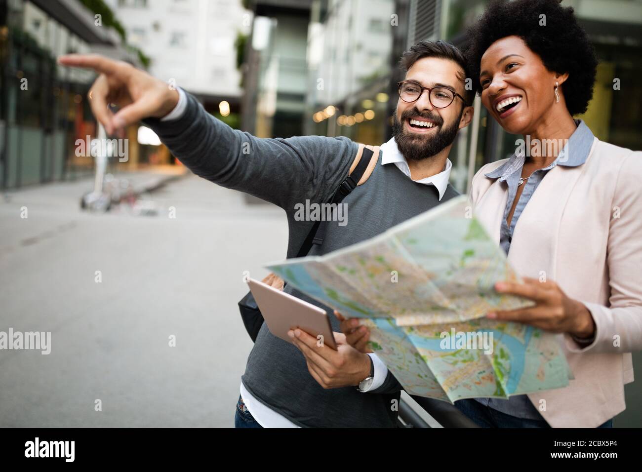 Happy tourists sightseeing city with map. Travel, people, fun concept ...