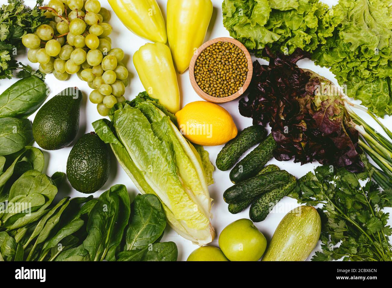 Organic green vegetables, herbs, fruits and mung beans on white ...