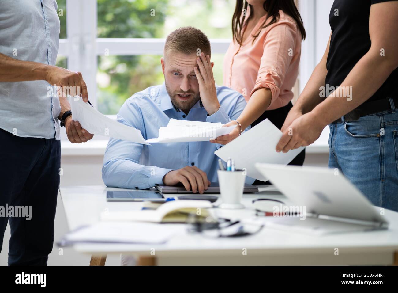 Stress At Workplace In Office. Business Headache Stock Photo - Alamy