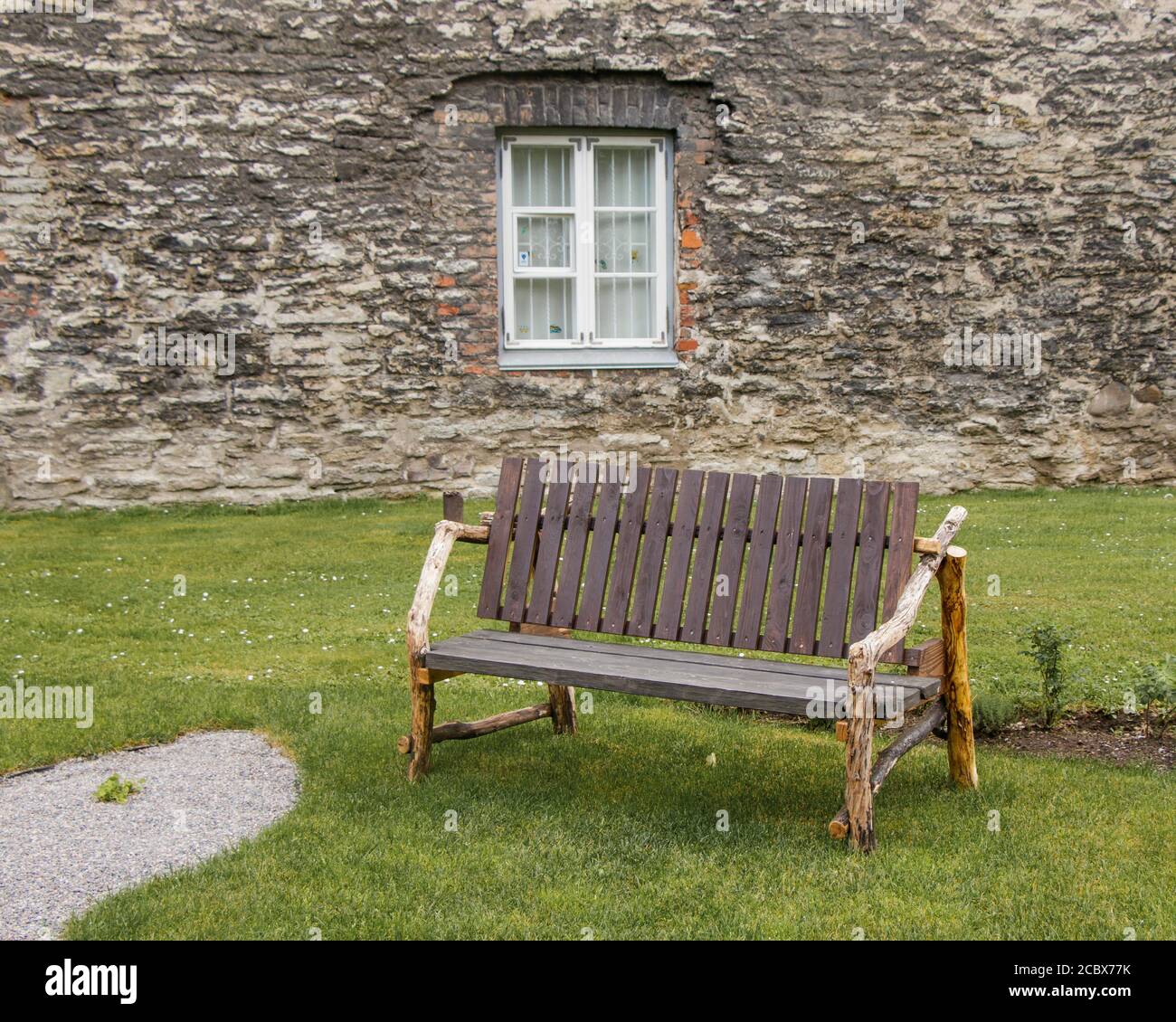 Unusual bench made of boards and branches Stock Photo - Alamy