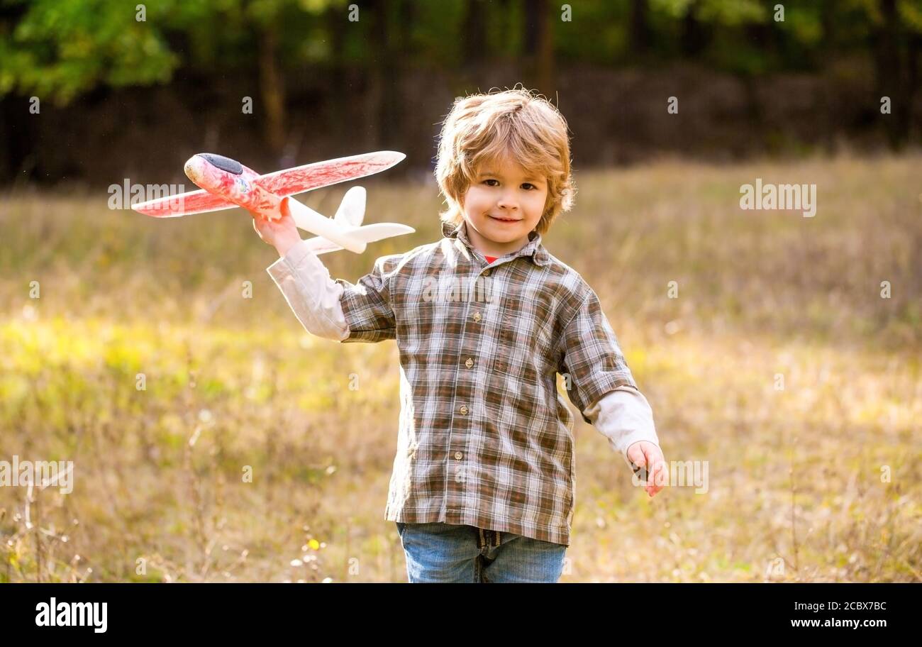 Child playing with toy airplane. Happy child playing. Happy child ...