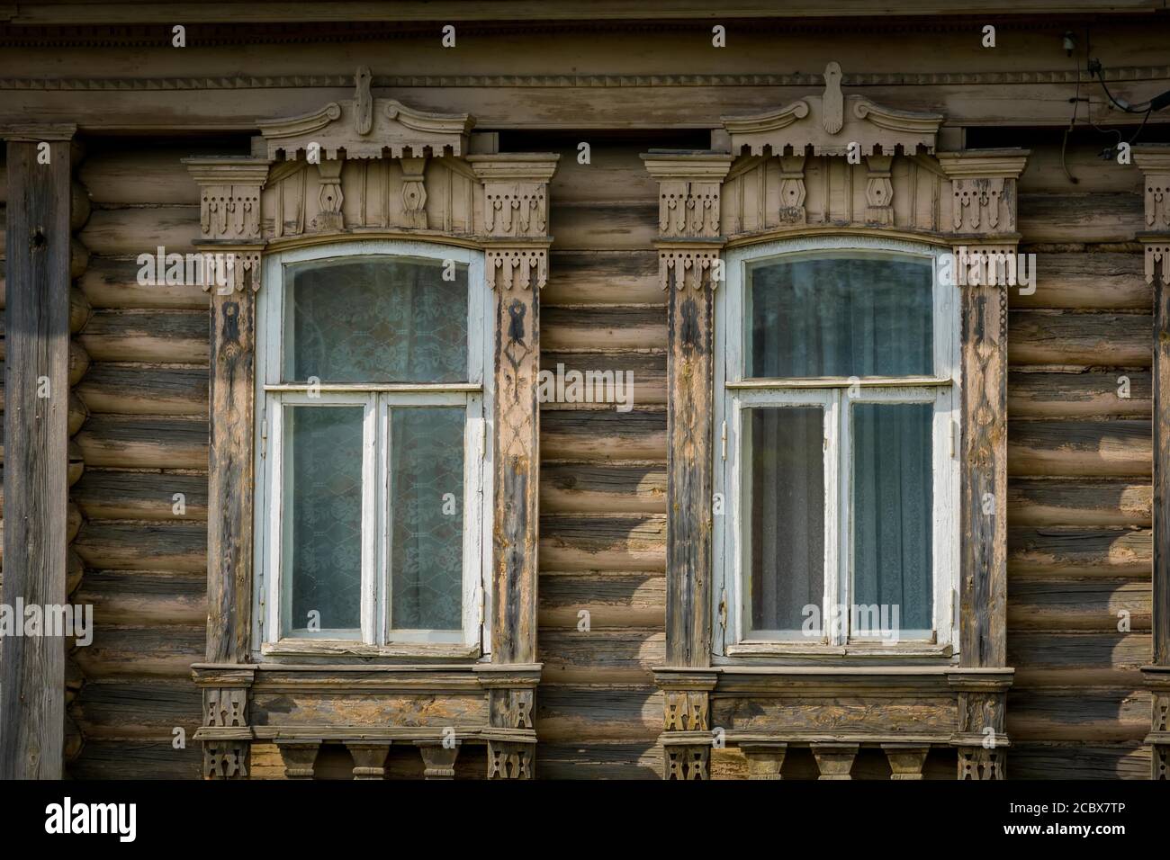 Old wooden house with decorative carved windows background Stock Photo ...