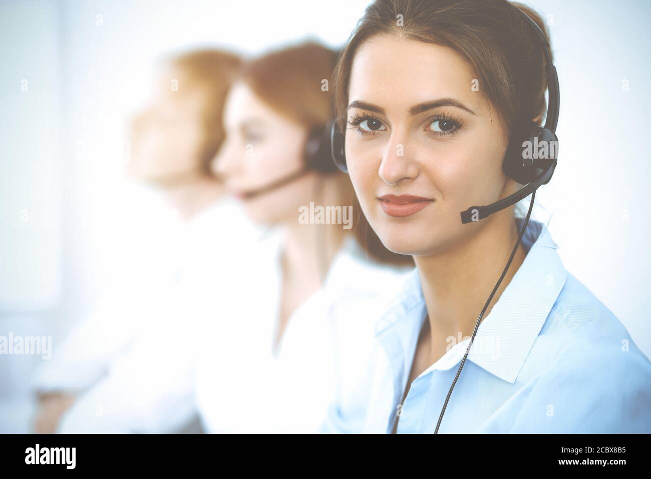 Call center. Focus on beautiful business woman in headset Stock Photo ...