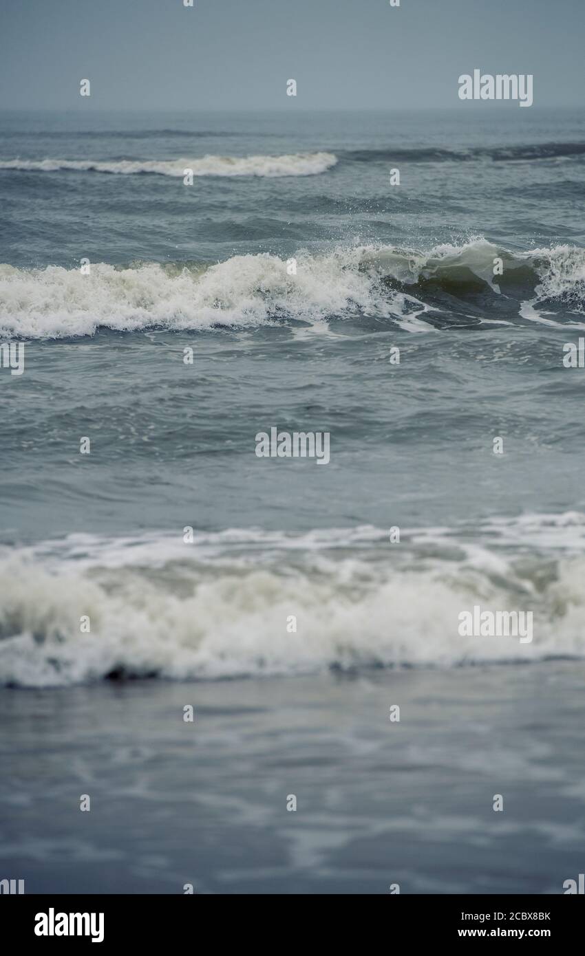 Waves and the incoming tide off the coast of the Netherlands Stock ...