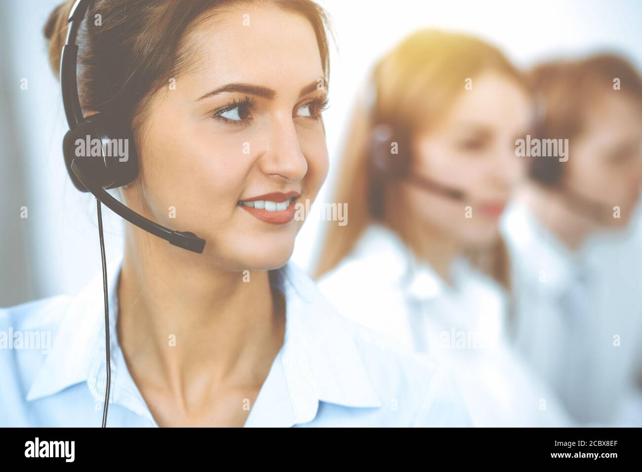 Call center. Focus on beautiful business woman in headset Stock Photo ...