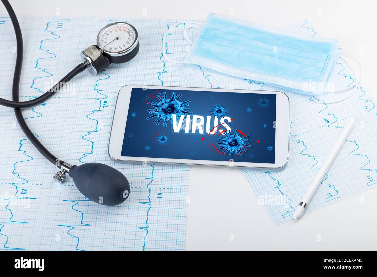 Tablet pc and doctor tools on white surface with VIRUS inscription ...