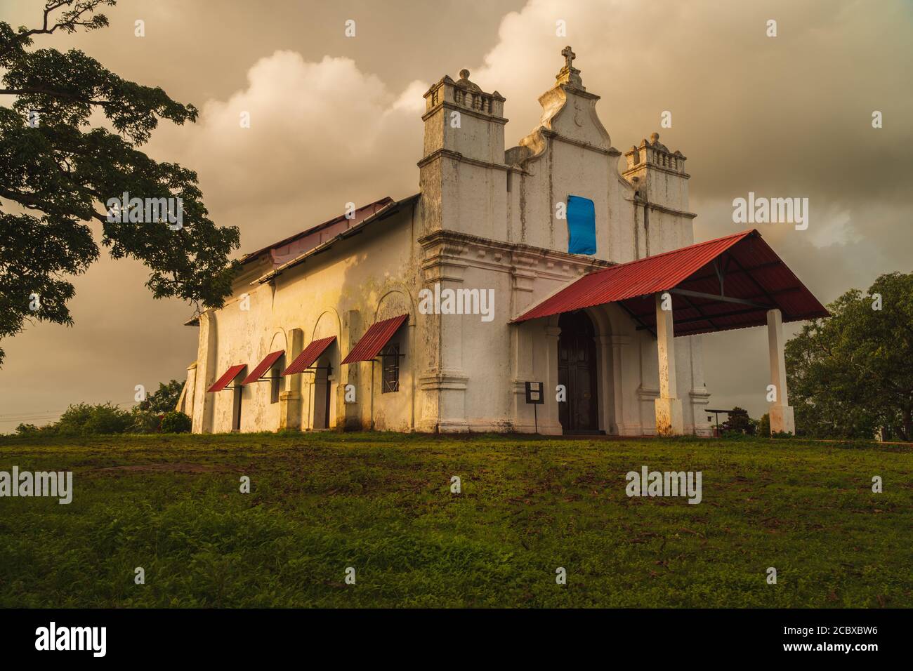 As monsoon clouds roll-in on the Three Kings chapel with Portuguese ...
