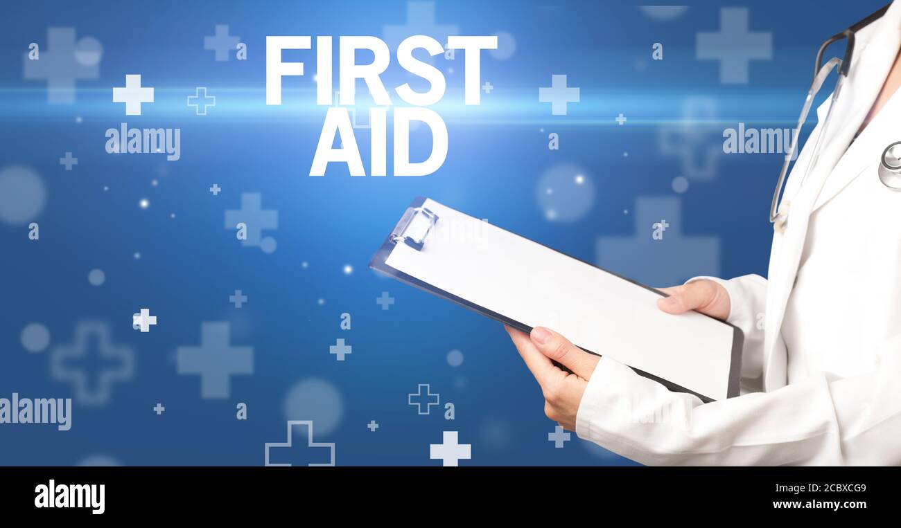 doctor writes notes on the clipboard with FIRST AID inscription, first ...