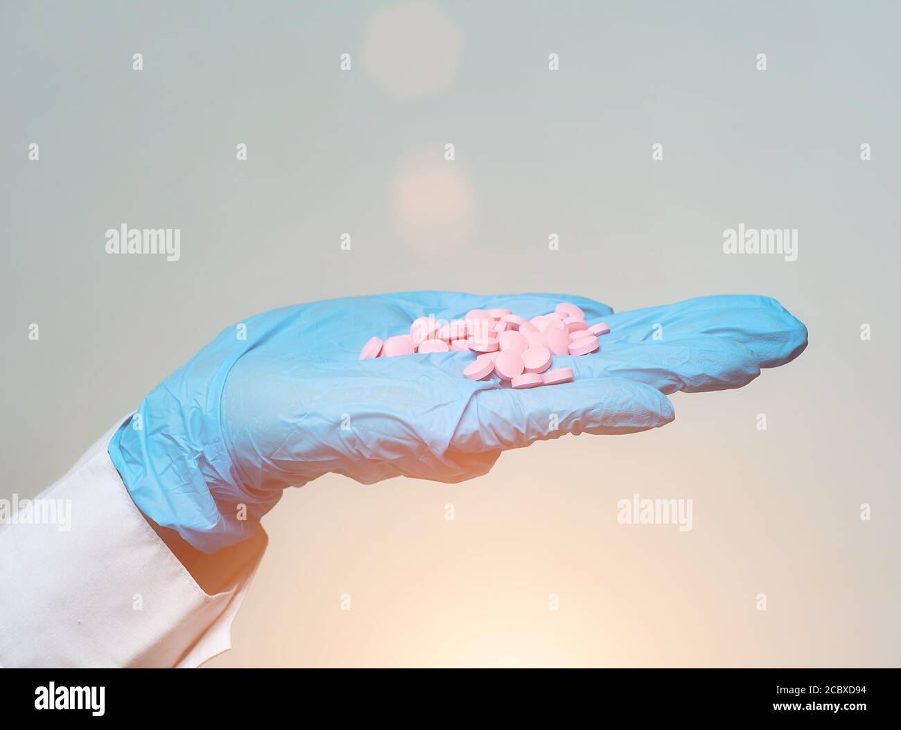 the gloved doctor shows the tablets in the palm of his hand Stock Photo ...