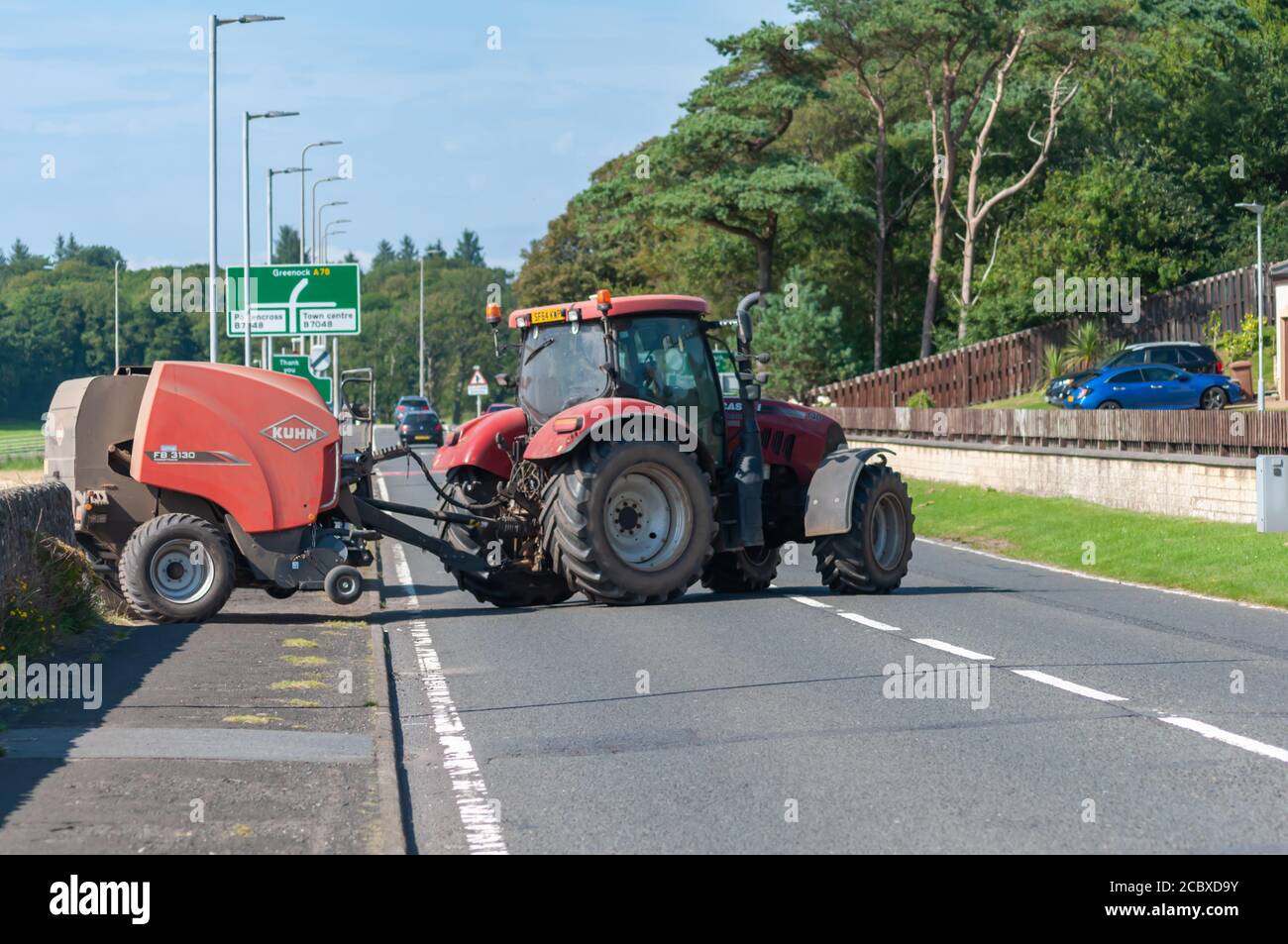 West Kilbride, Scotland, UK. 16th August 2020. A tractor towing a hay ...
