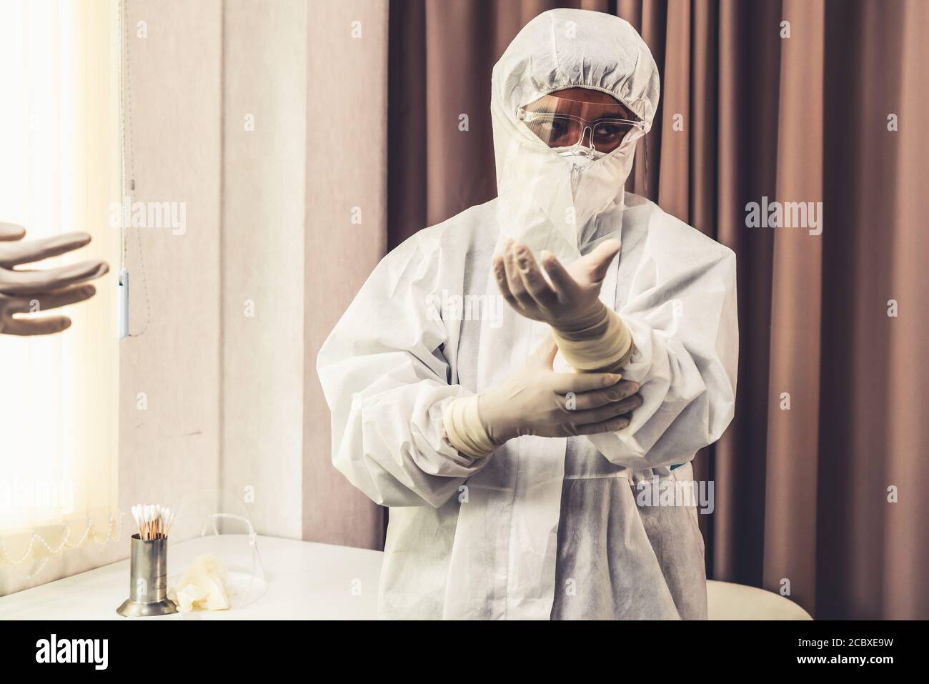 Doctor in PPE suit , face mask and face shield in hospital ward Stock ...