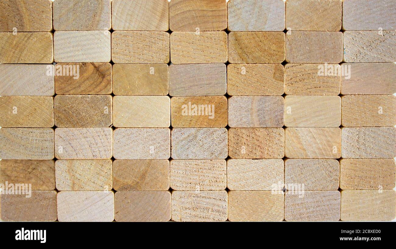 Photo of many small wooden cubes of different heights, tightly lying ...