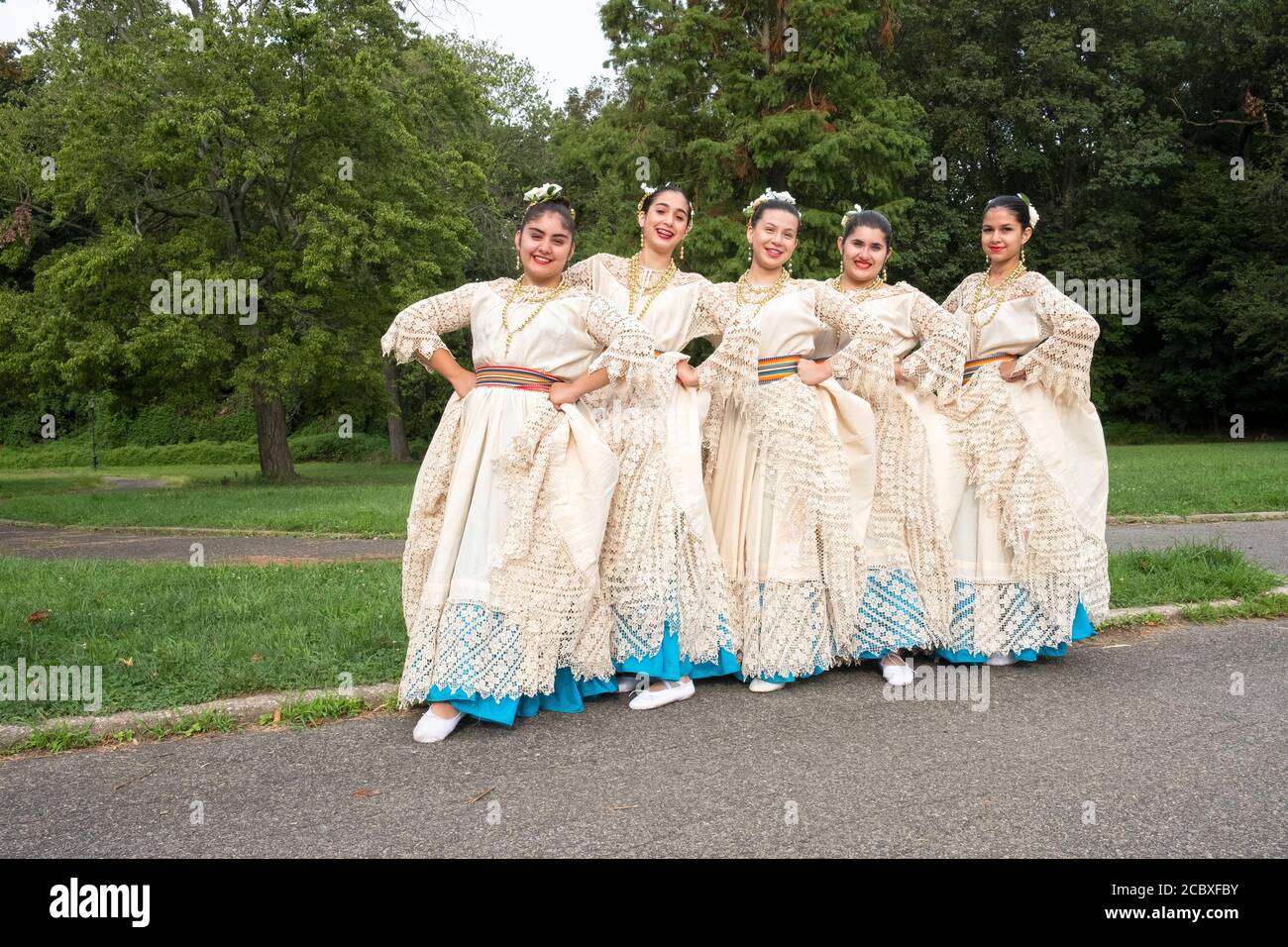 Posed portrait of a group of Paraguayan American folk dancers in native ...