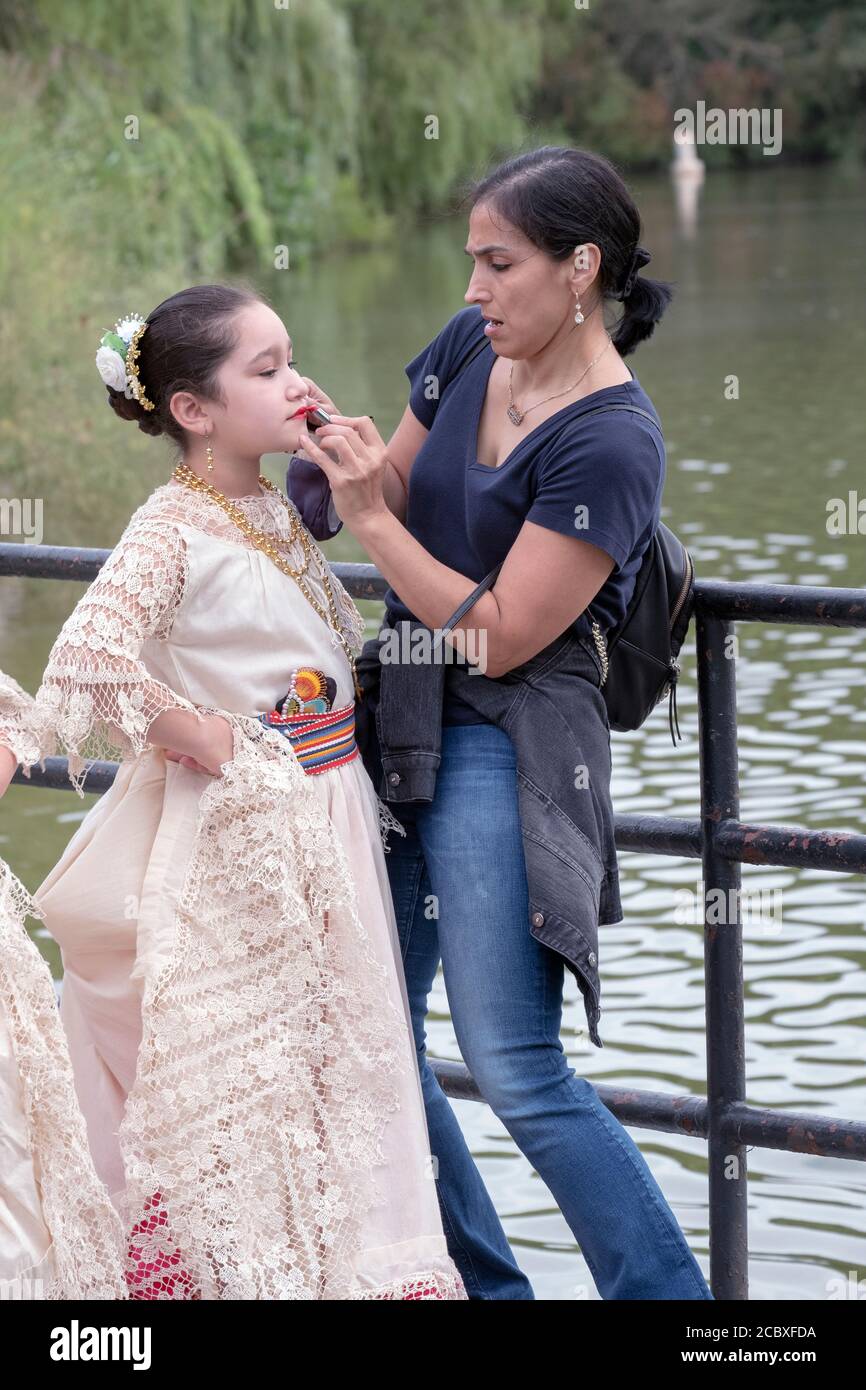 An sweet looking young dancer gets a makeup adjustment at a photo shoot ...