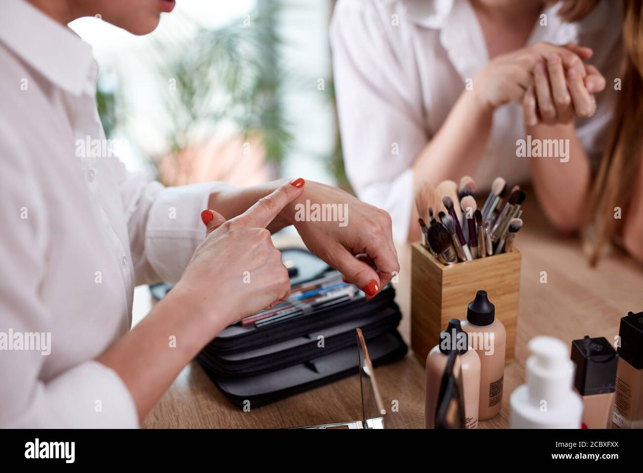 professional make-up artist shows master class to students, she is ...