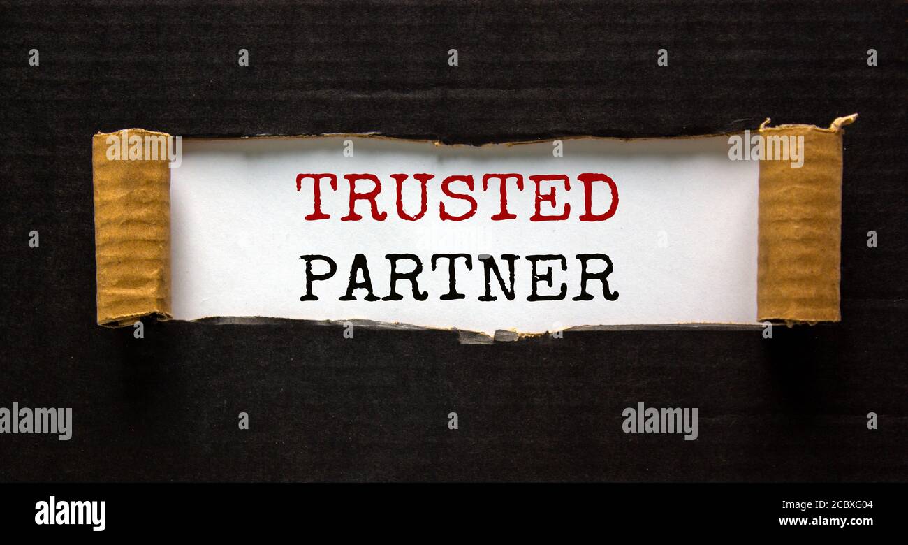 The word 'trusted partner' appearing behind torn black paper. Beautiful ...