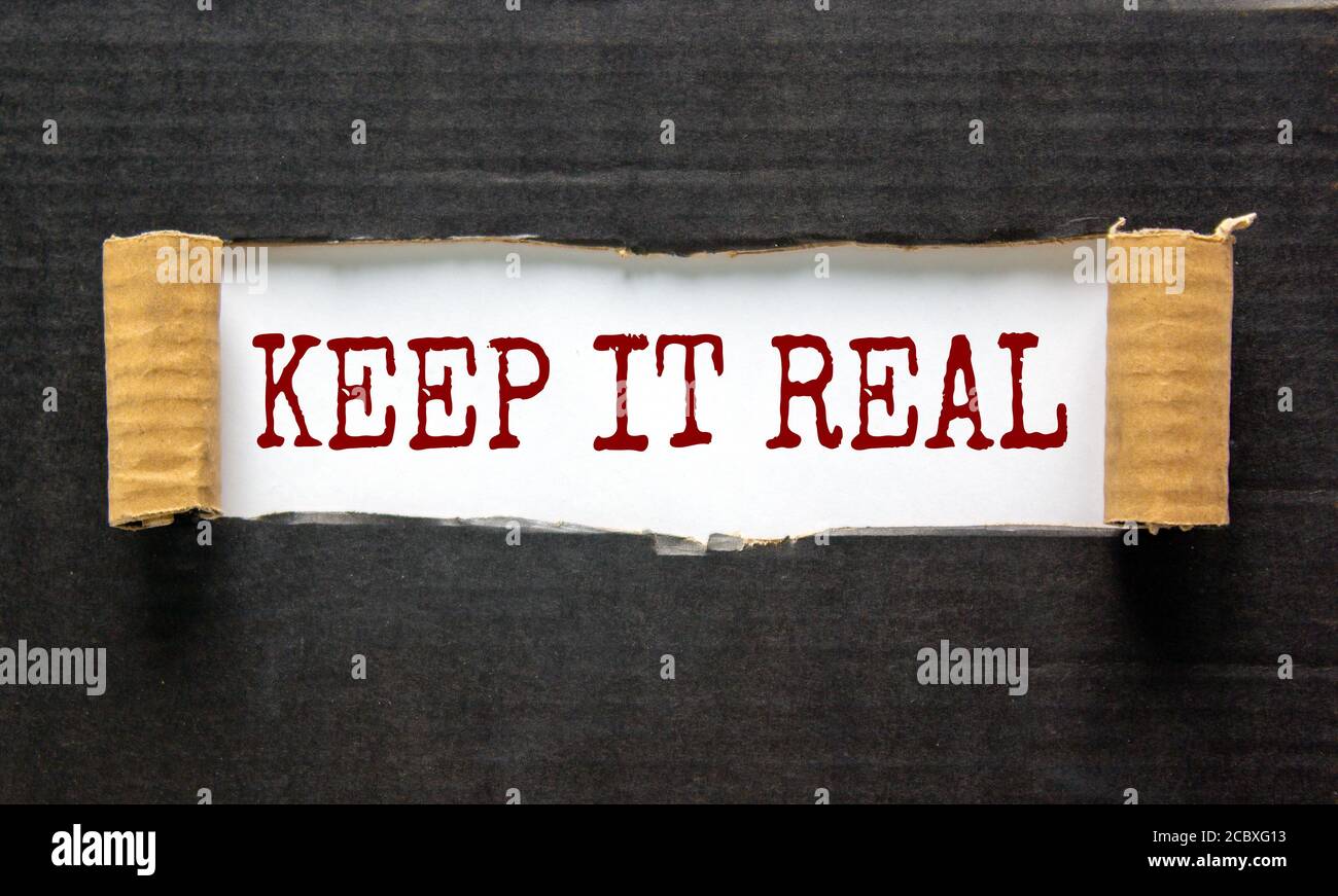 The words 'keep it real' appearing behind torn black paper. Beautiful ...
