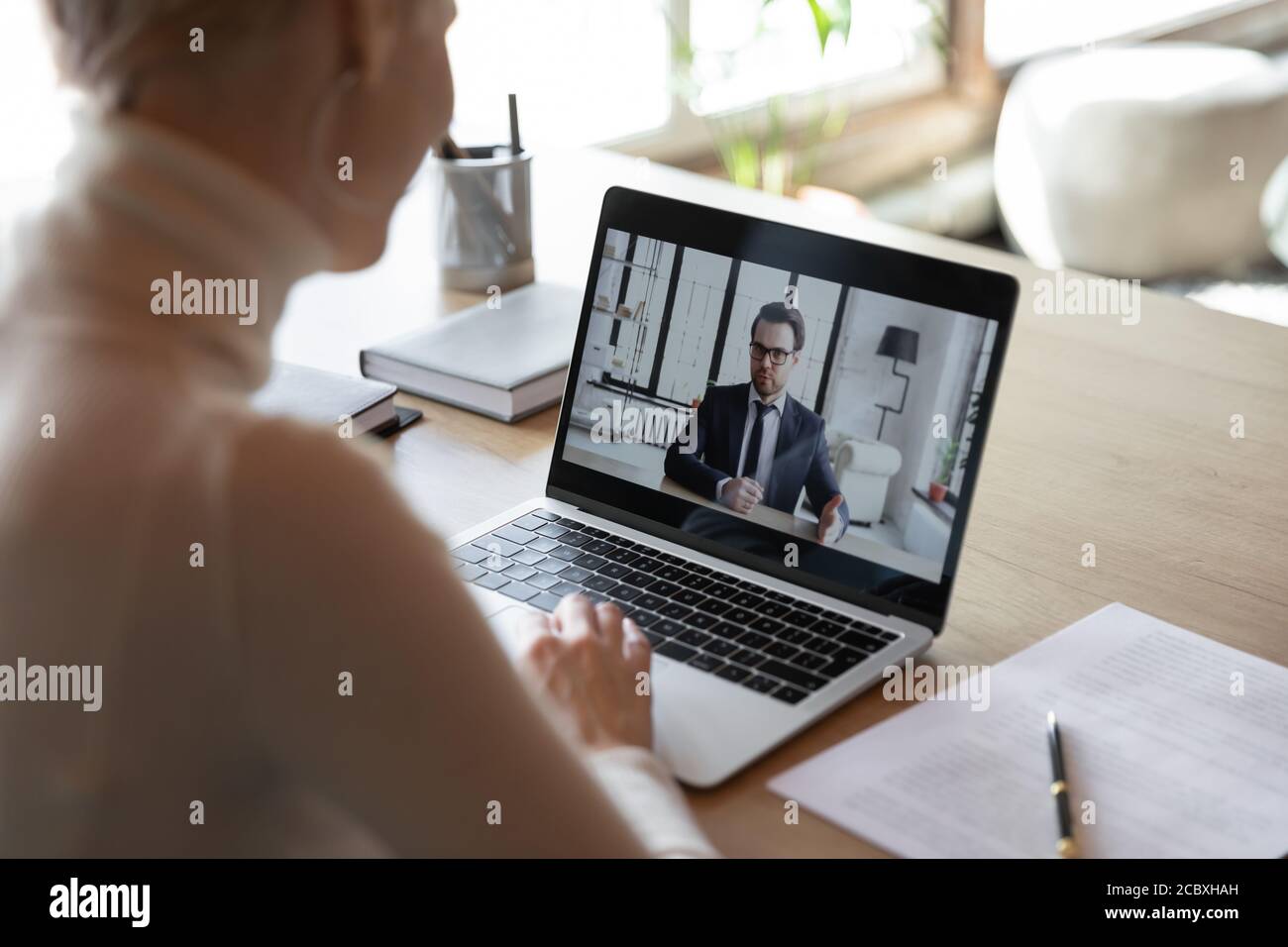 Focus on computer screen with confident coach giving consultation Stock ...
