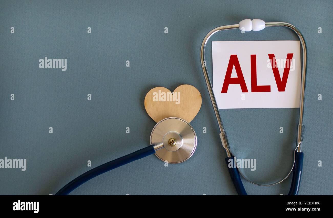 White card with words 'alv' and stethoscope on blue background. Wooden ...