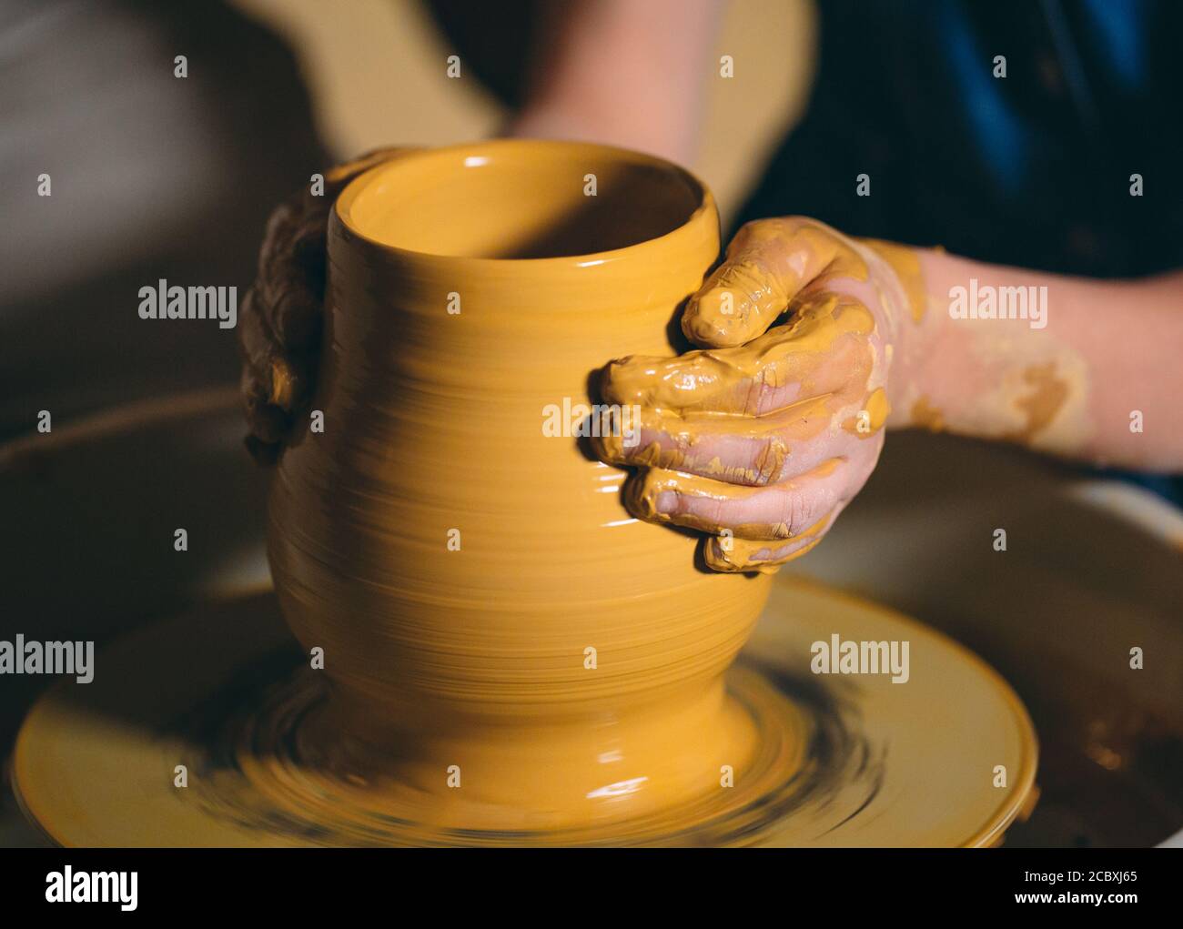 Pottery workshop. A little girl makes a vase of clay. Clay modeling ...