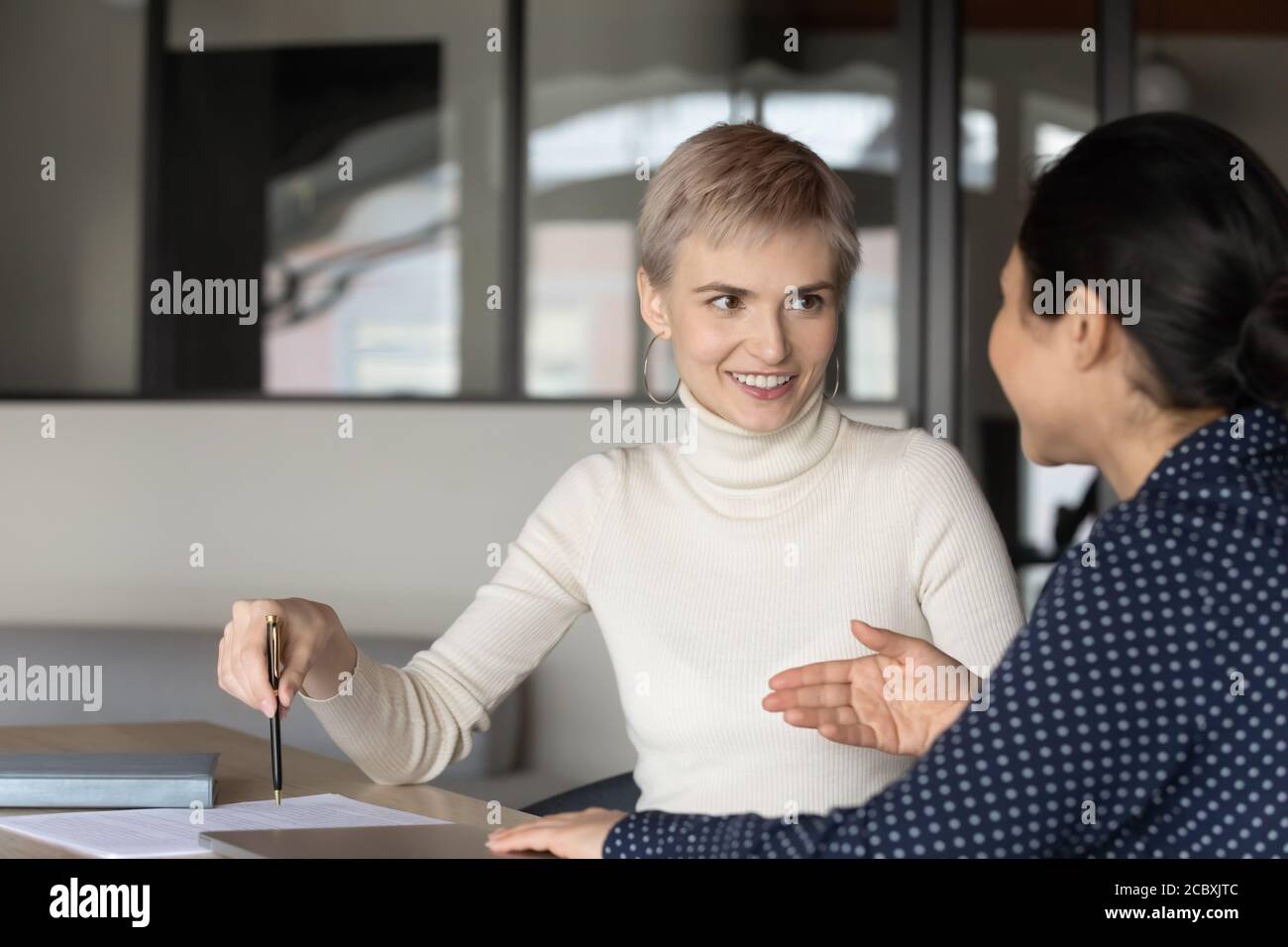 Happy diverse female partners developing company growth strategy Stock ...