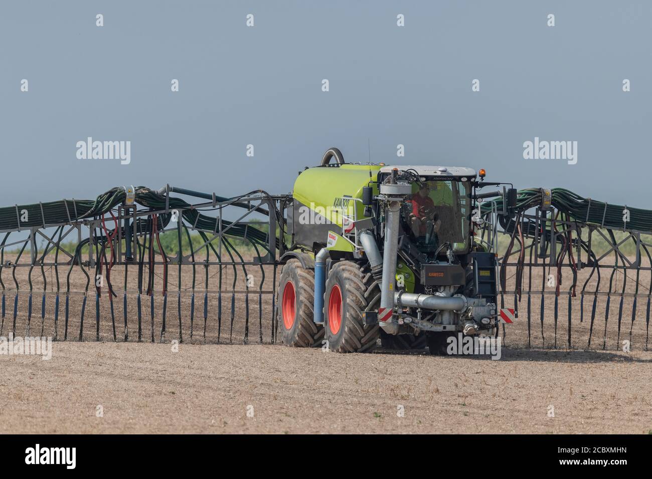 Slurry injector working in large sterile arable field, spring; Dorset ...