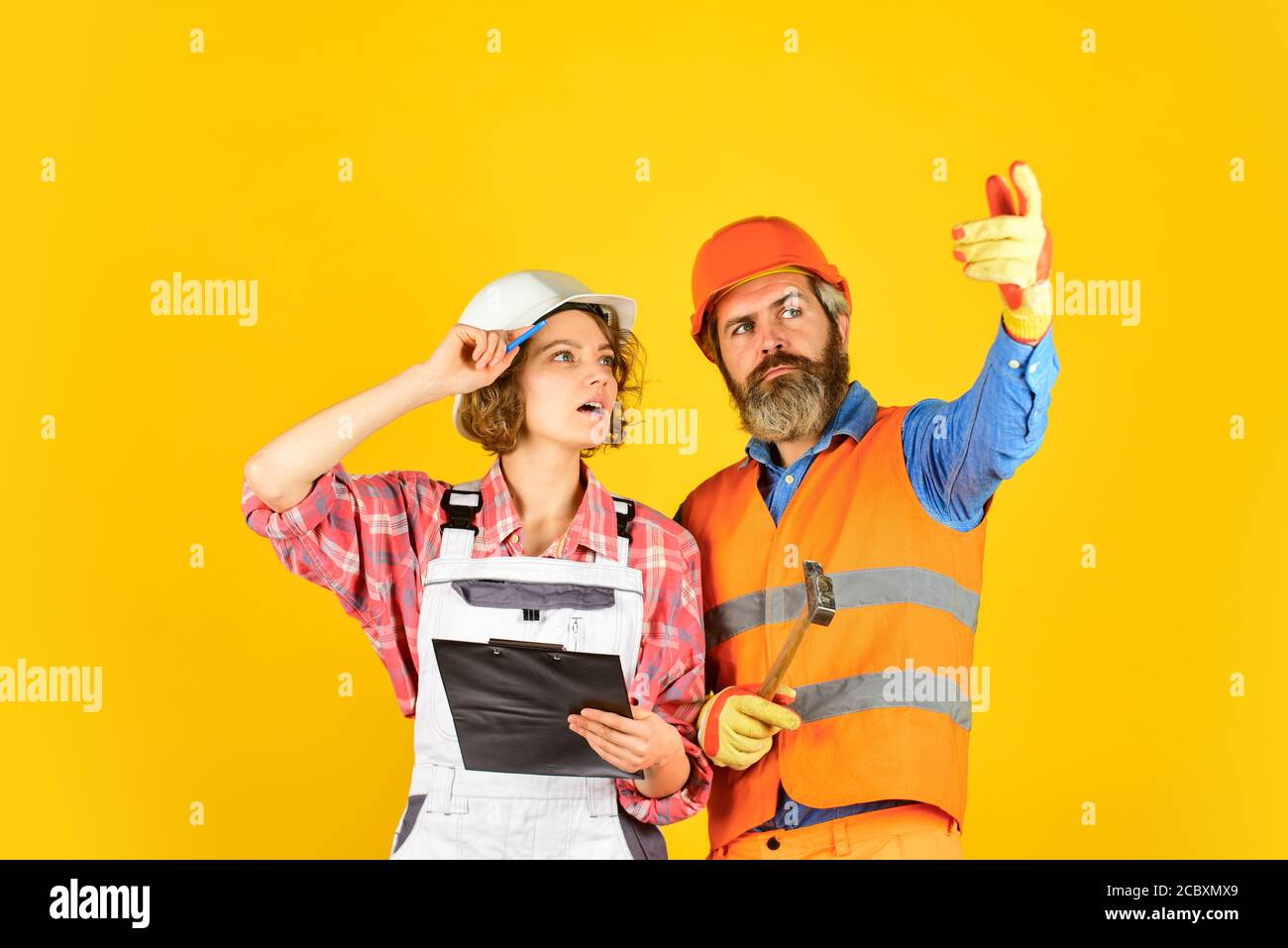Builder Couple Look At Home Plans. couple looking at a blueprint. woman ...