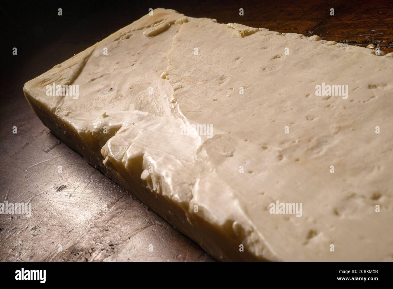 a block of homemade soap by mixing ash and water to produce lye and ...