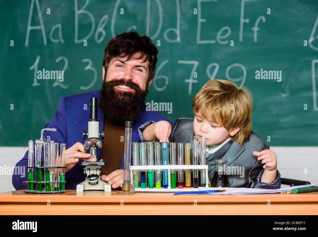 Little kid learning chemistry in school laboratory. father and son at ...