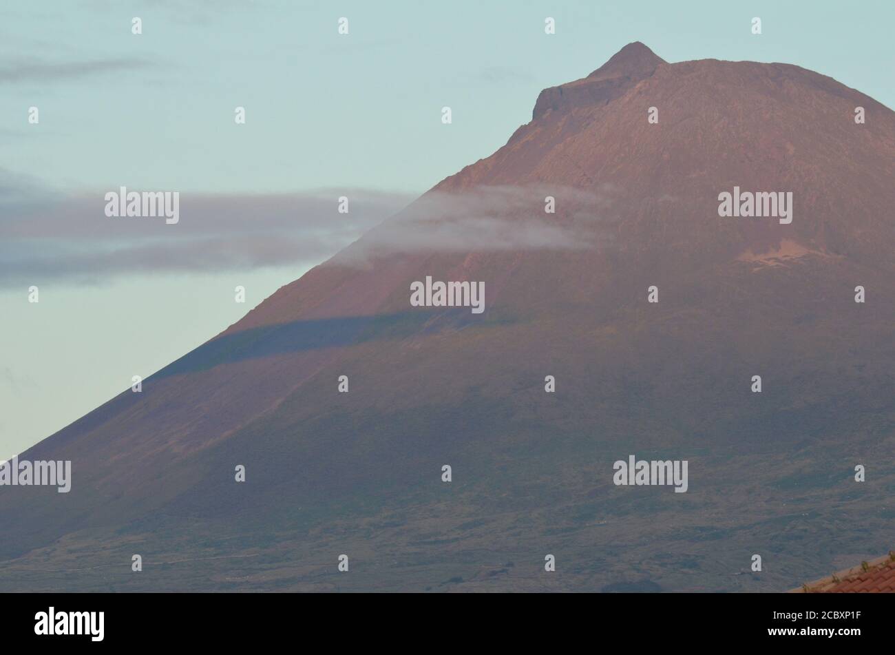 The conical Pico volcano looming over its namesake island, Azores ...