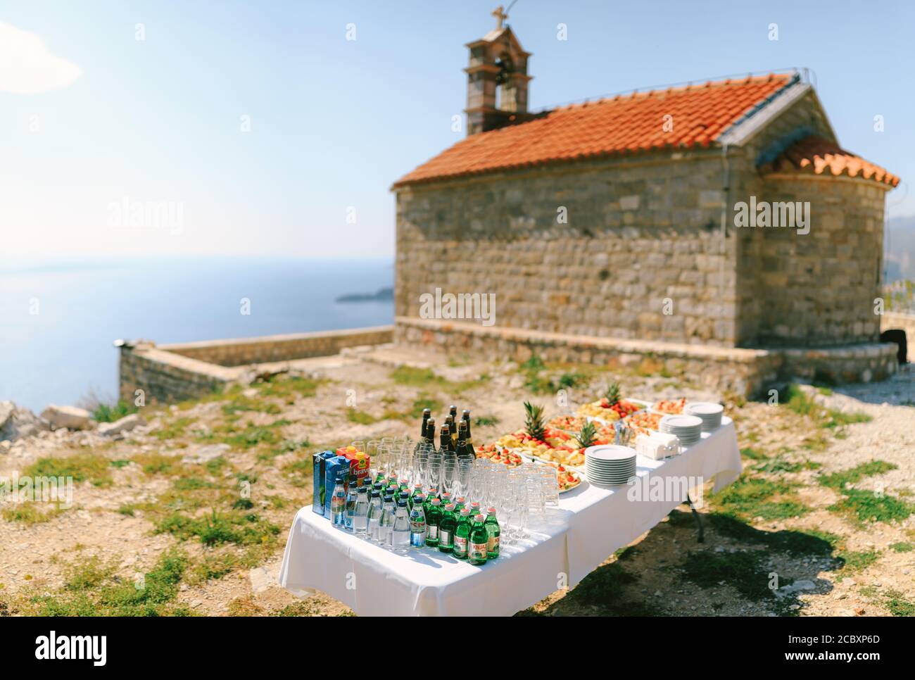 Festively served buffet table with water, champagne and fruits on ...