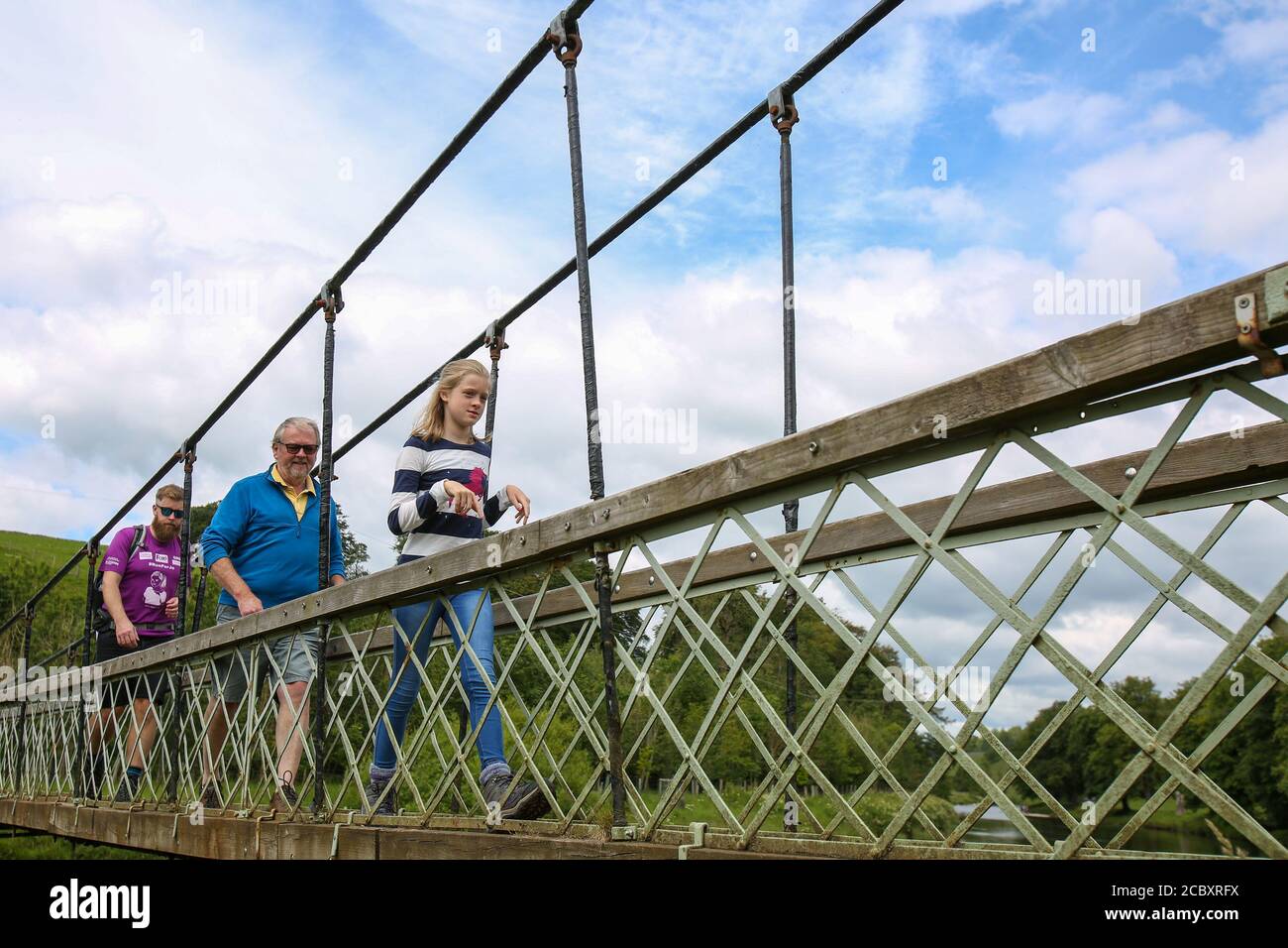 Three generation family crossing Hebden Suspension Bridge in North ...