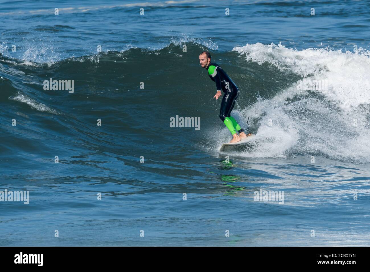 Surfer in action on the ocean waves on a sunny day Stock Photo - Alamy