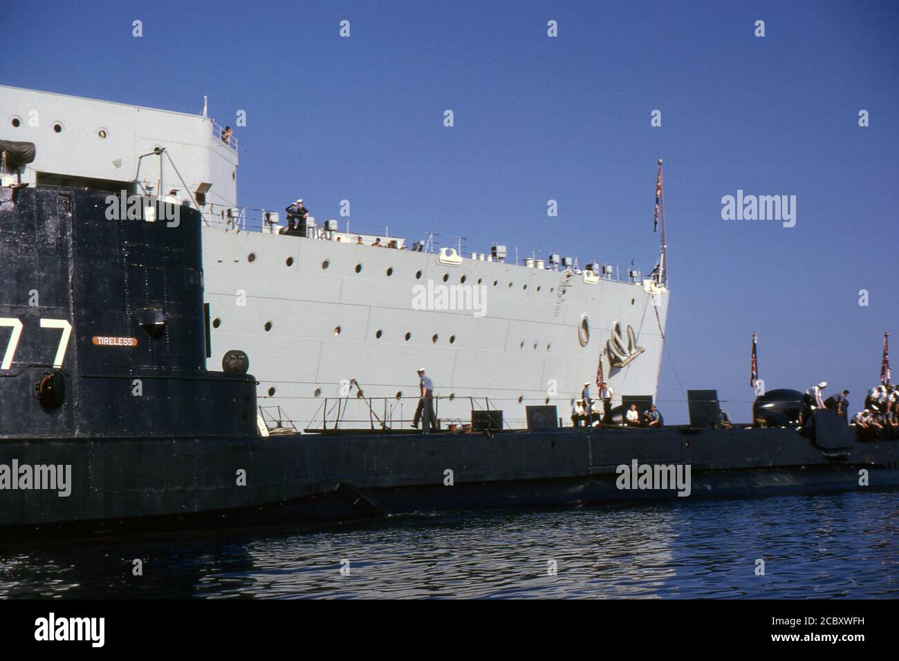 The Royal Navy T-class submarine, H.M.S. Tireless (S77) alongside the ...