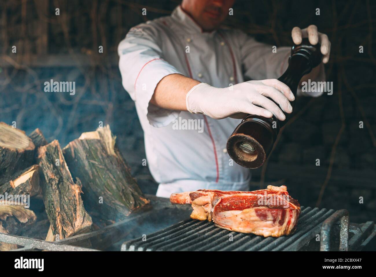 Chef pepper the steak on fire. Beef steak is cooked on fire. Beef Rib ...