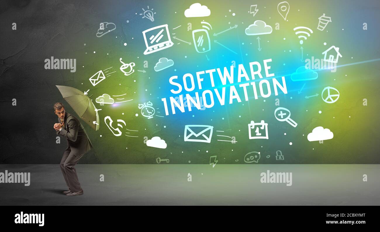 Businessman defending with umbrella from SOFTWARE INNOVATION ...