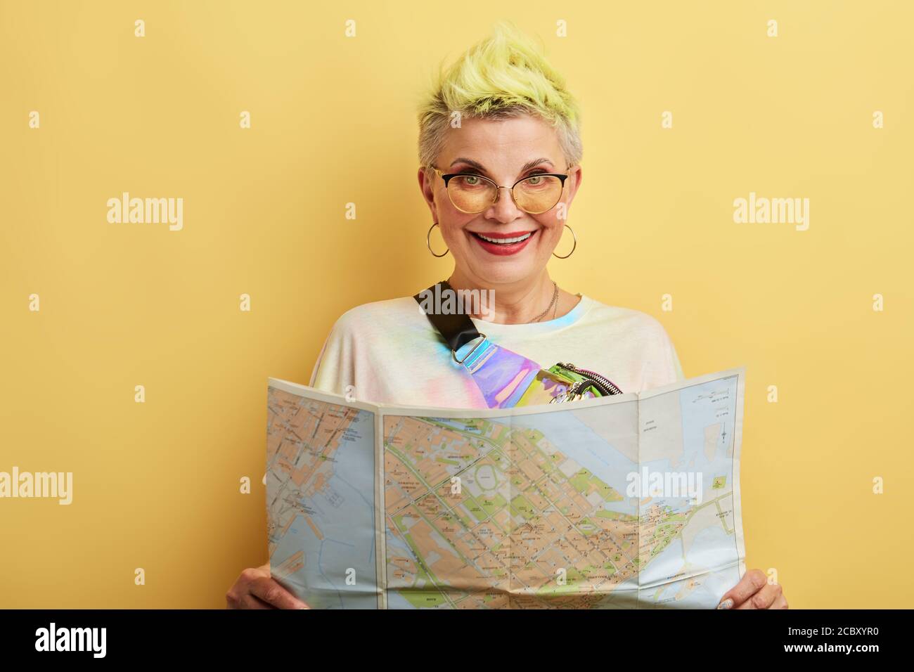 positive old holidaymaker making up decision where to travel. close up ...