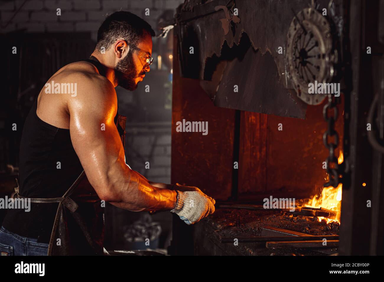 Portrait of a professional brutal caucasian blacksmith with strong ...