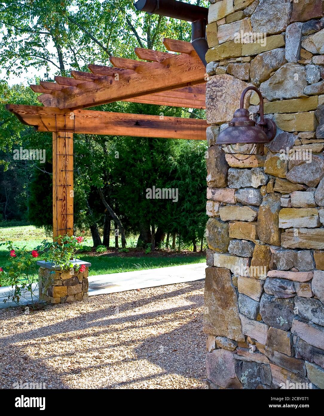 Wood Arbor and Stone wall garage Stock Photo - Alamy