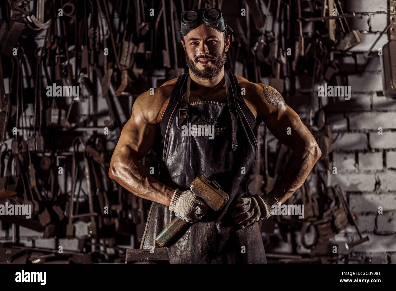portrait of young smiling muscular strong caucasian man blacksmith ...