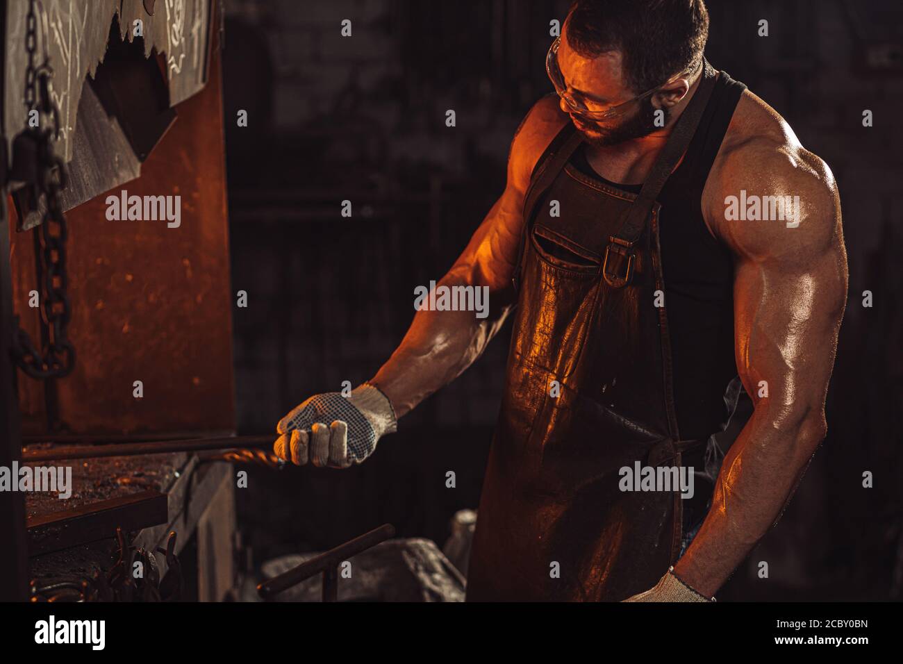 Portrait of a professional brutal caucasian blacksmith with strong ...