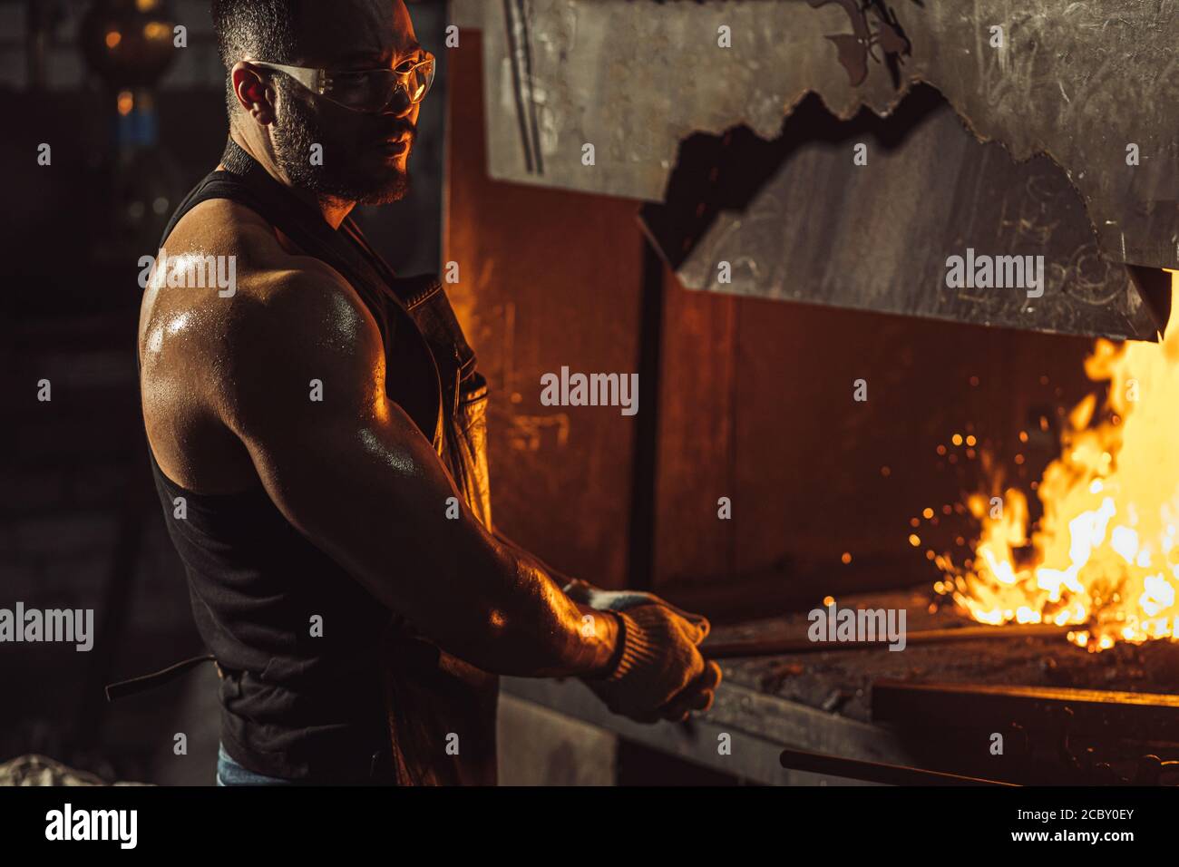 young caucasian powerful blacksmith man with muscular hands, stand ...
